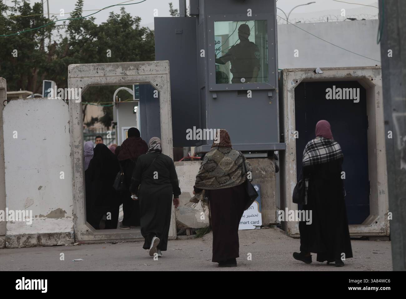 Palestinians cross an Israeli army checkpoint in Bethlehem, in the ...