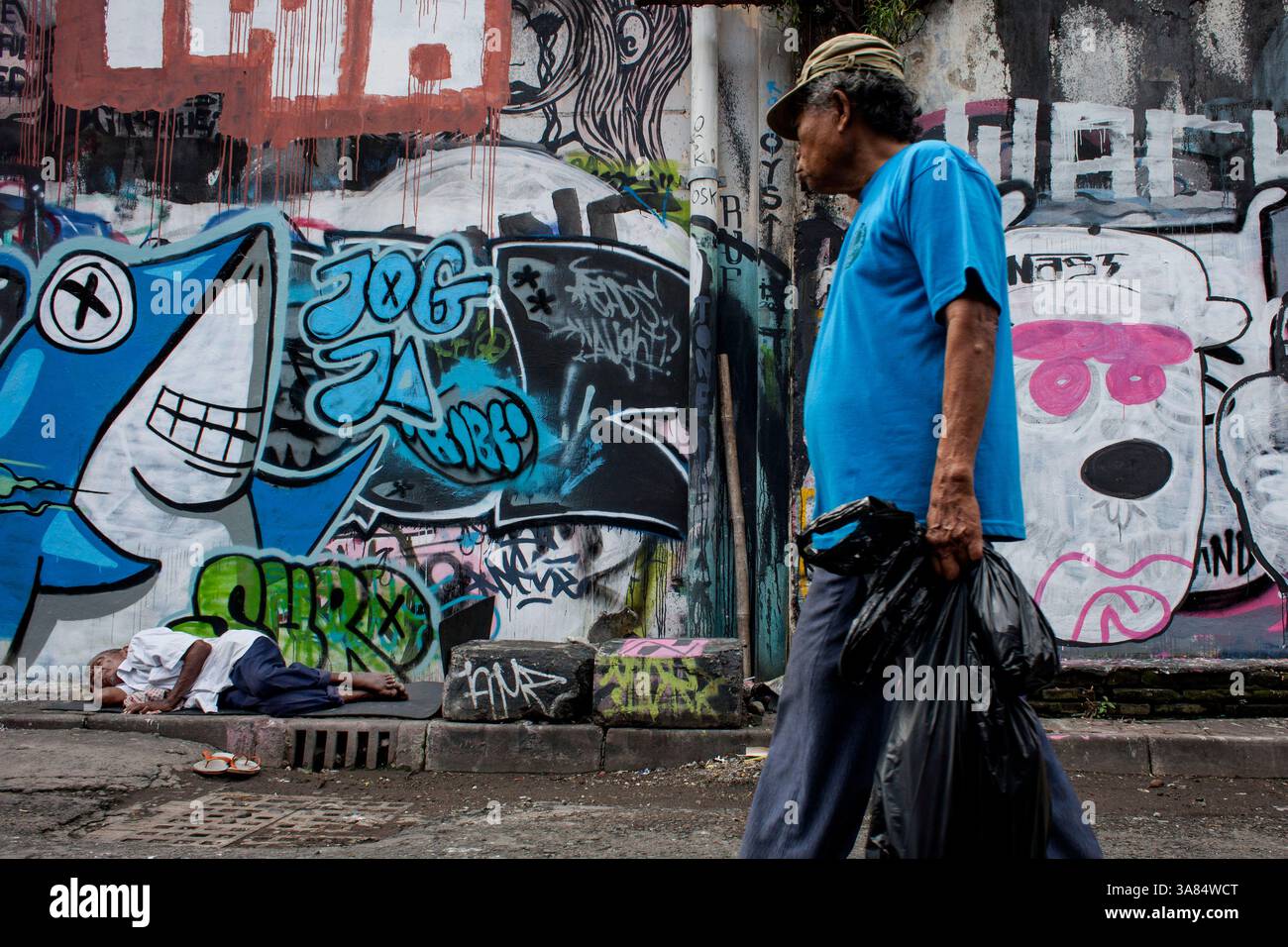 May 15, 2013 - Yogyakarta, Indonesia - Man sleep under a mural ...