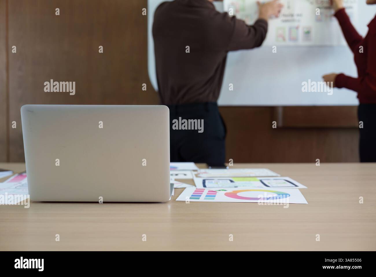 Focused UX UI Development. A laptop and design materials lay on a table ...