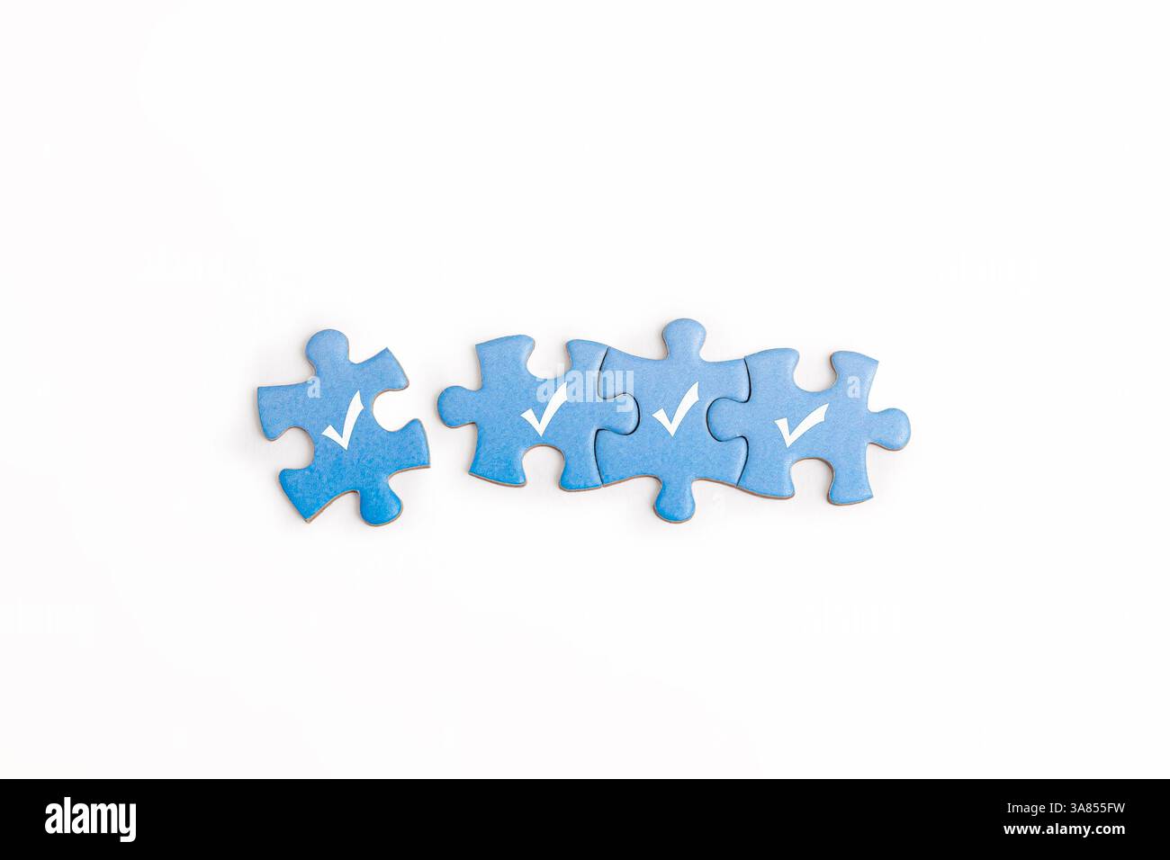Four blue puzzle pieces with white checkmarks are arranged in a row on ...