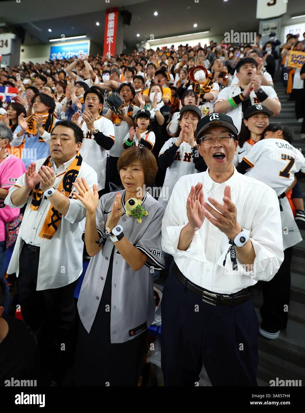 Baseball fans watch the season-opening game of Nihon professional baseball (NPB) between the ...