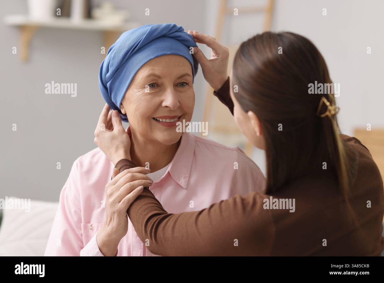 Caregiver helping woman with cancer at home Stock Photo - Alamy