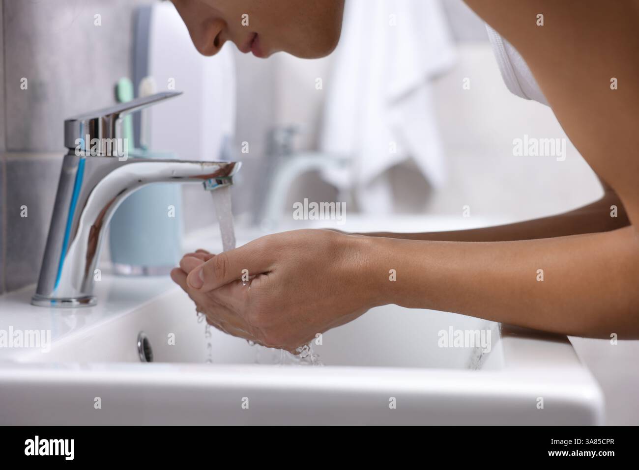 Man washing his face over sink in bathroom, closeup Stock Photo - Alamy