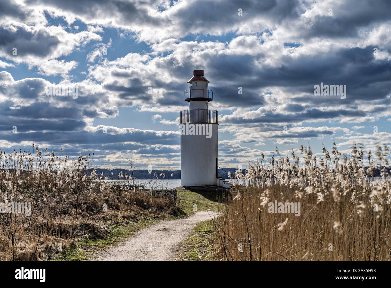 A serene lighthouse surrounded by coastal landscape, featuring a ...