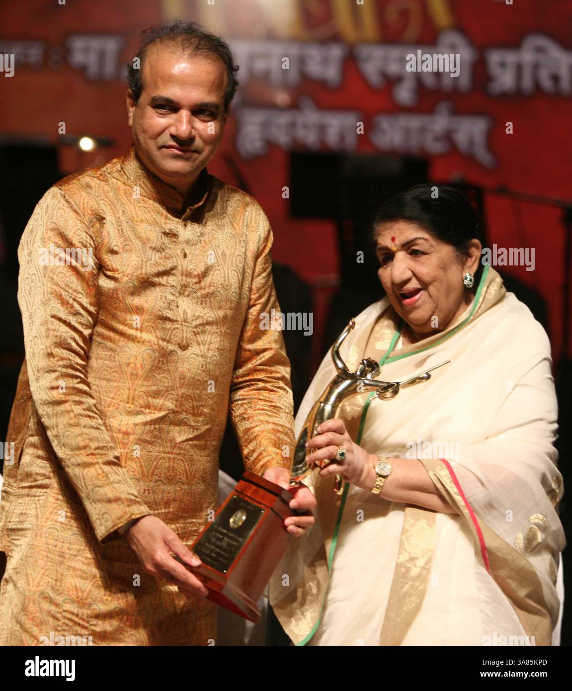 MUMBAI, INDIA â€“ APRIL 24: Singer Lata Mangeshkar gives award to ...