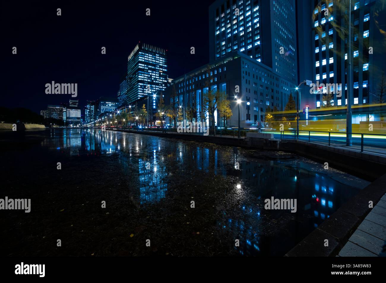 A night photography of traffic jam at the gingko tree street wide shot ...