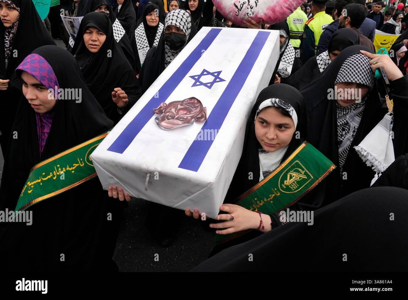 Iranian demonstrators carry a symbolic coffin for Israel with a ...