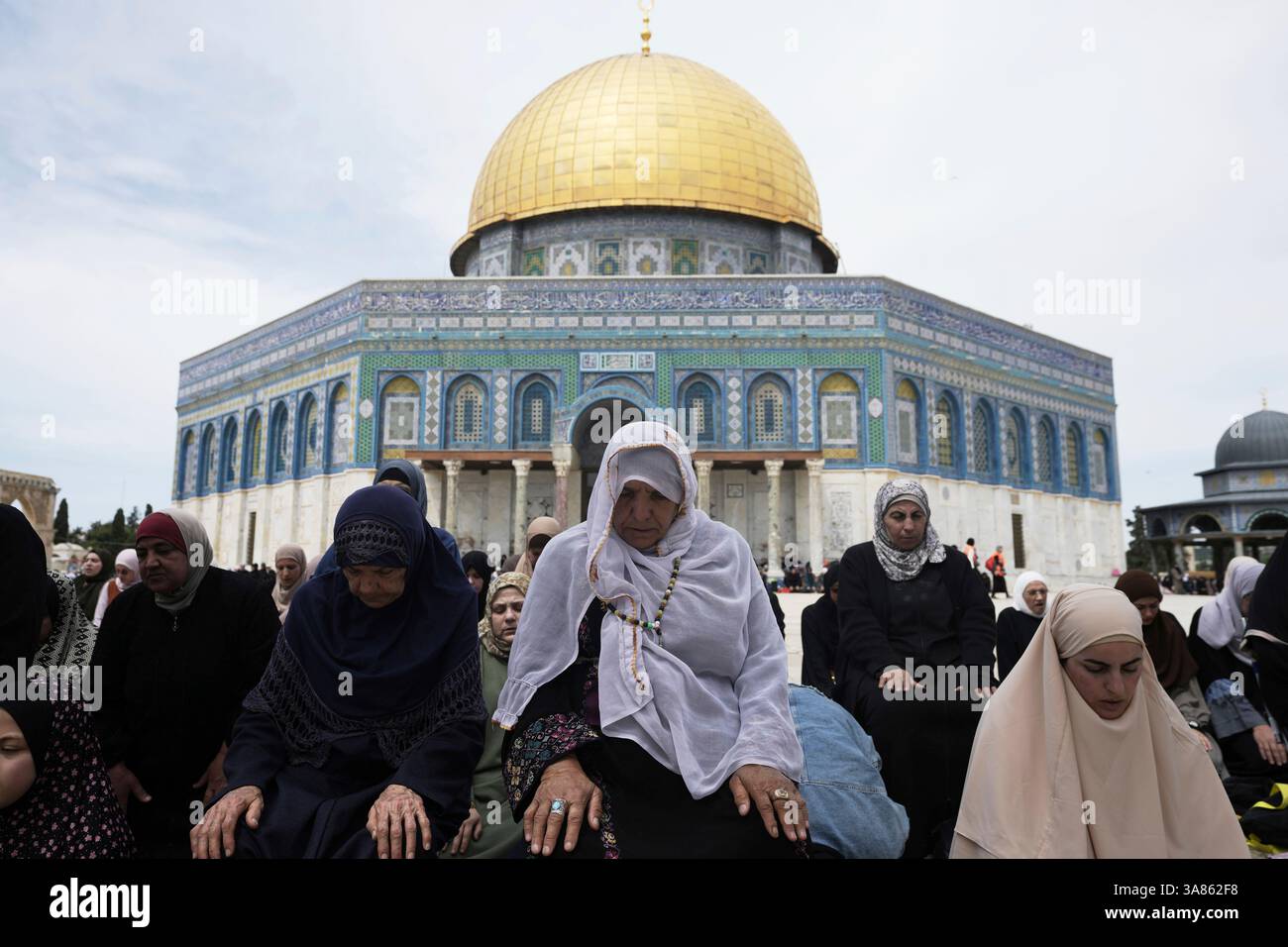 Women pray next to the Dome of the Rock Mosque in the Al-Aqsa Mosque ...