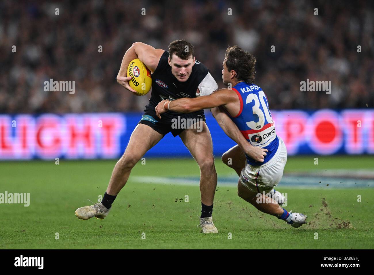 Blake Acres of Carlton (left) is tackled by Lachlan McNeil of Western ...