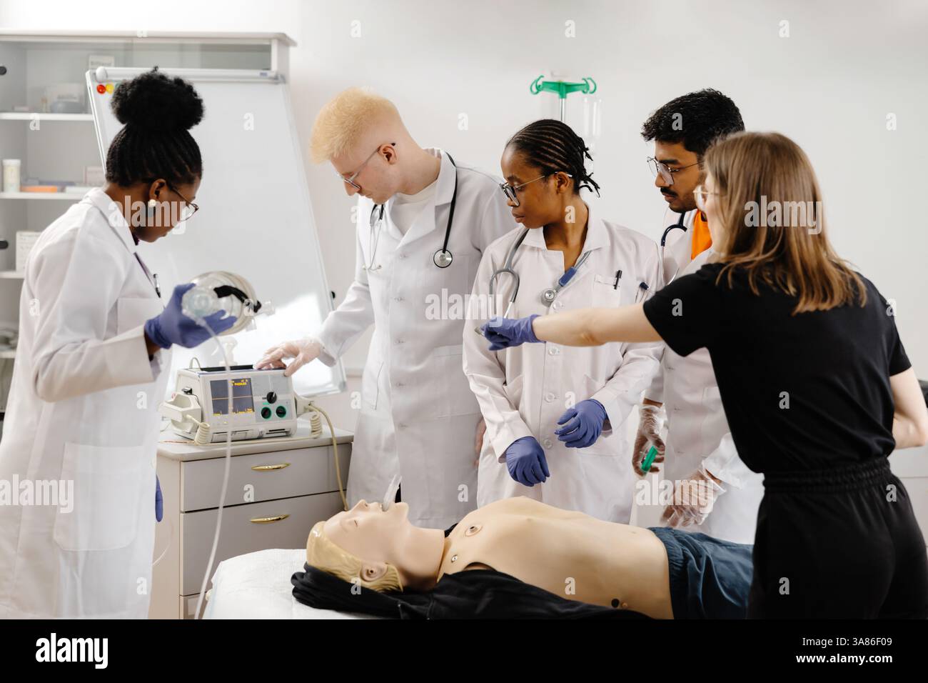 Group of diverse medical students learning how to perform ...