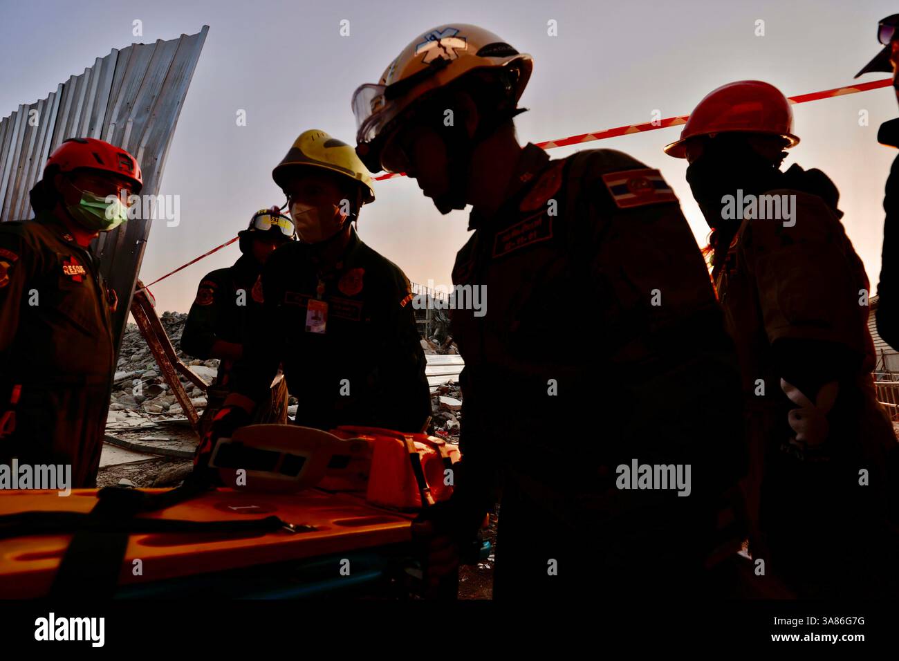 Rescuers work at the site a high-rise building under construction that ...
