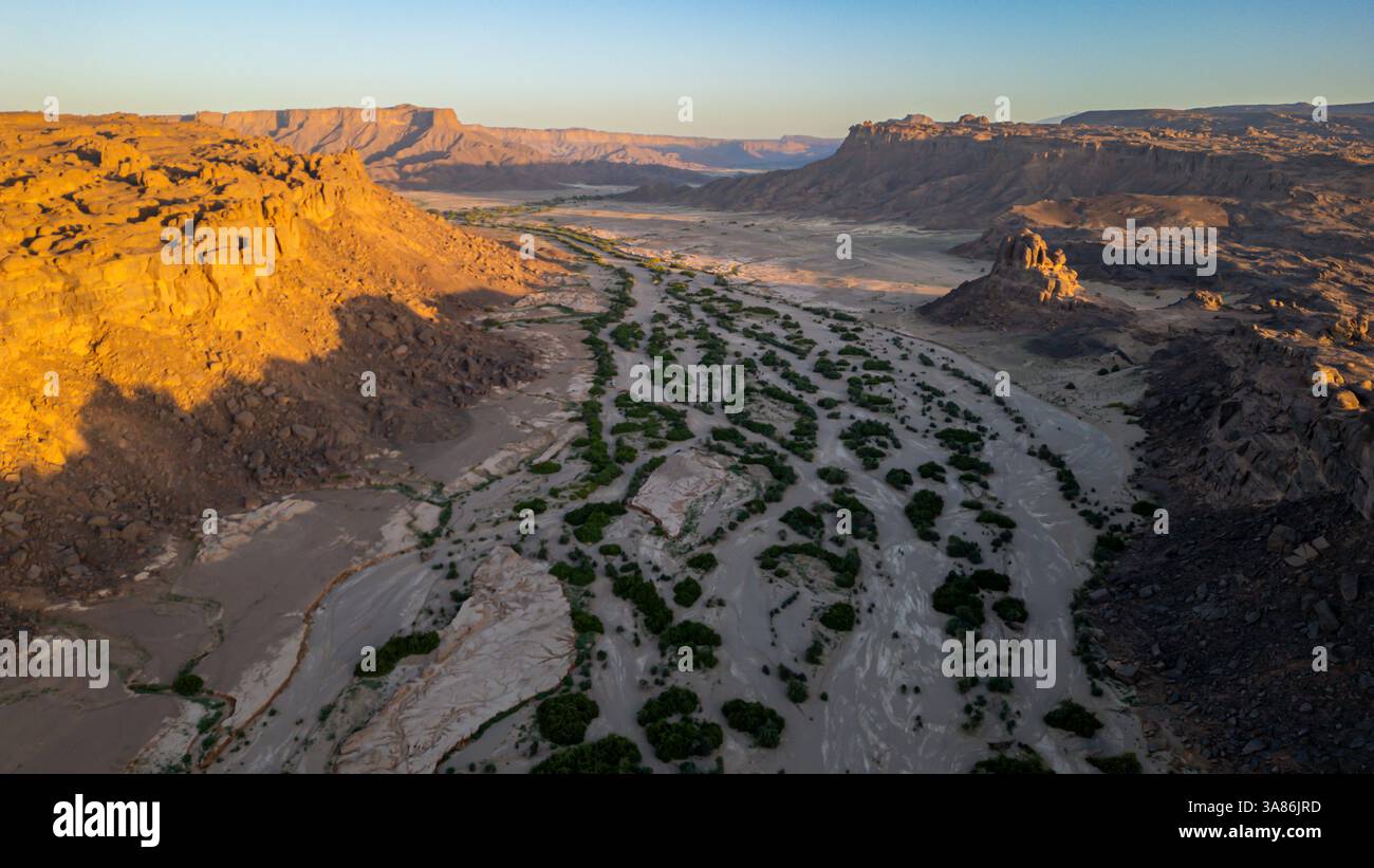 Aerial of the sunset over rocky mountains around Zouar, Tibesti ...