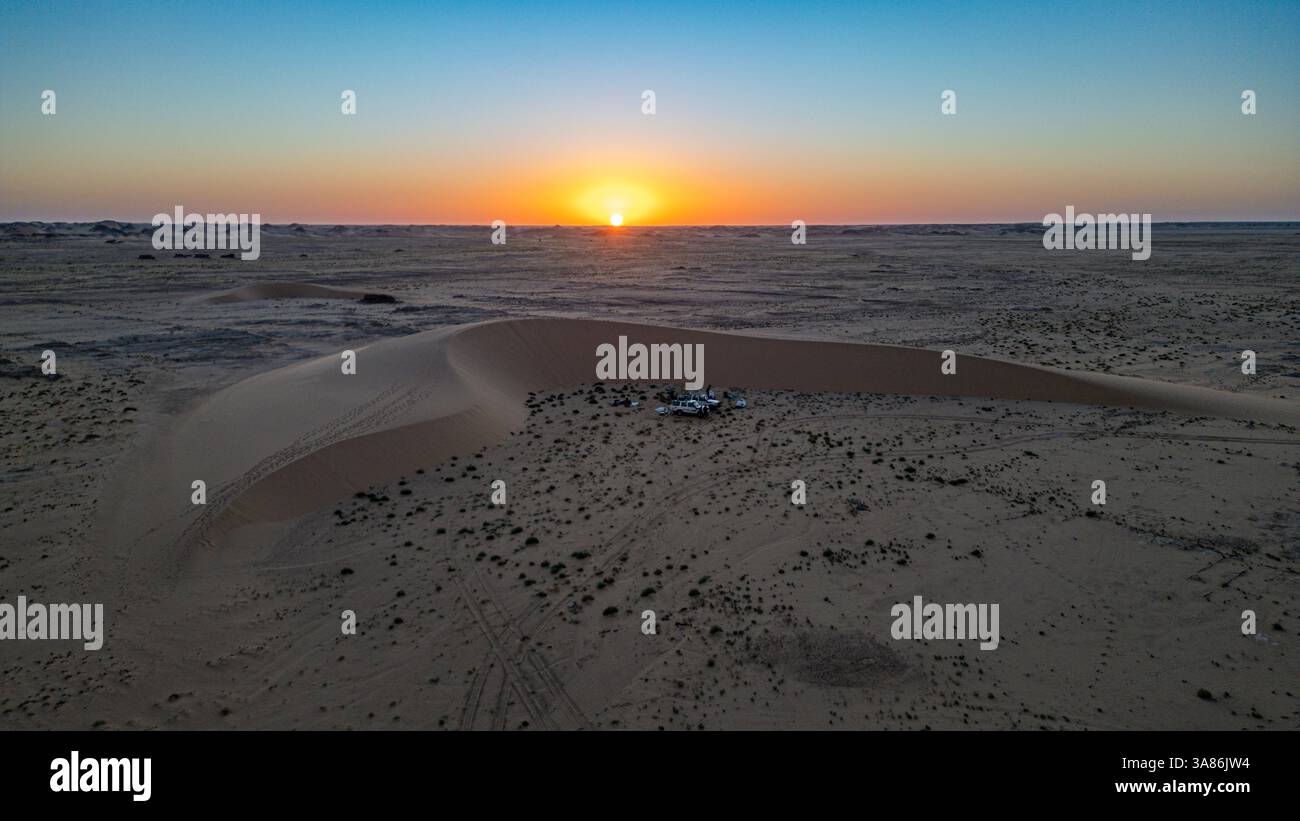 Aerial of sunset over a beautiful sand dune in the Tibesti Mountains ...