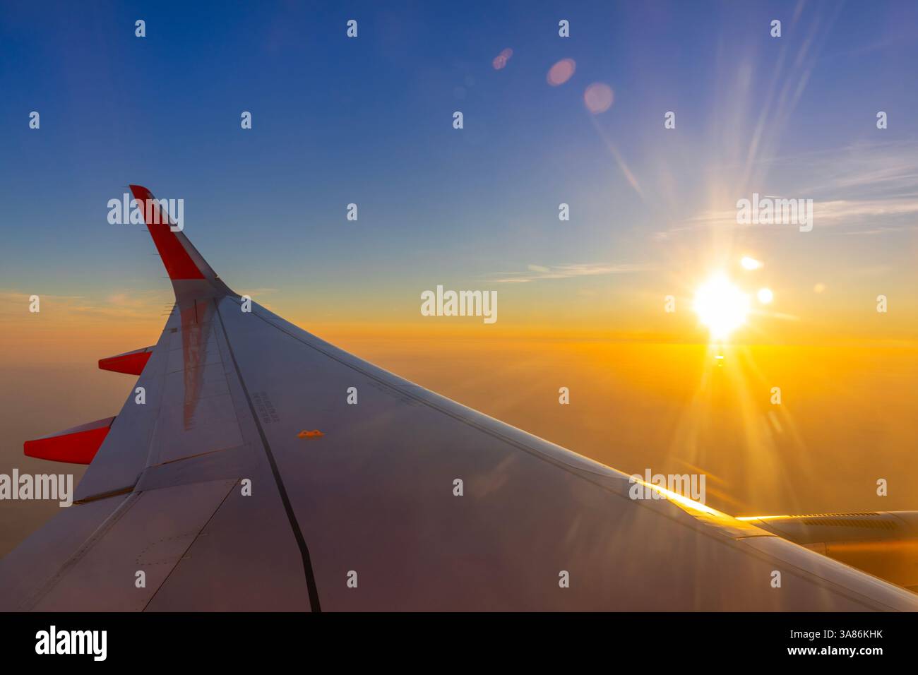 Aircraft plane wing, sunburst, sunset over England, United Kingdom ...