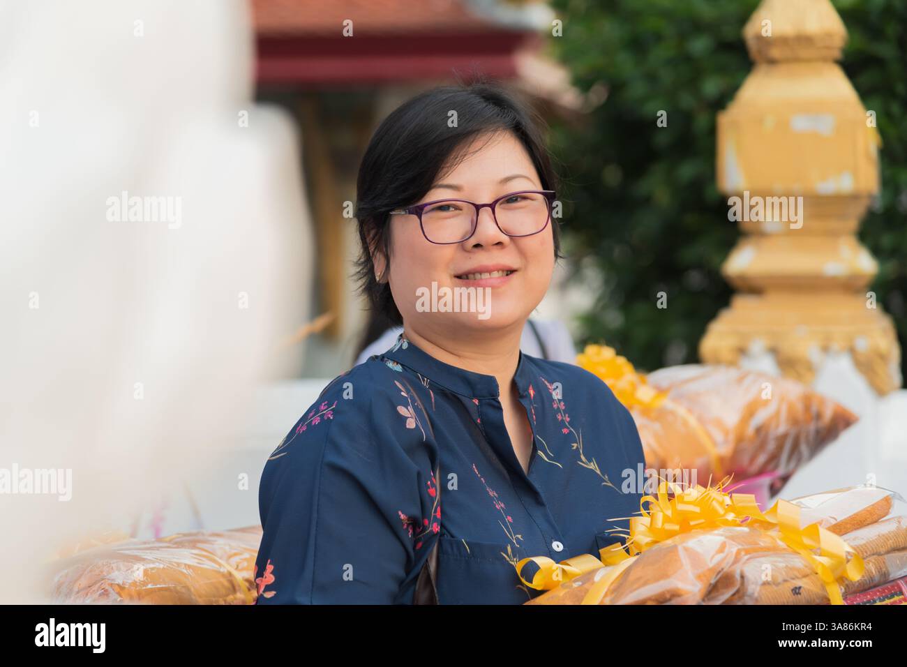 Asian woman 40s plump body hold the monk robe in parade for Thai monk ...