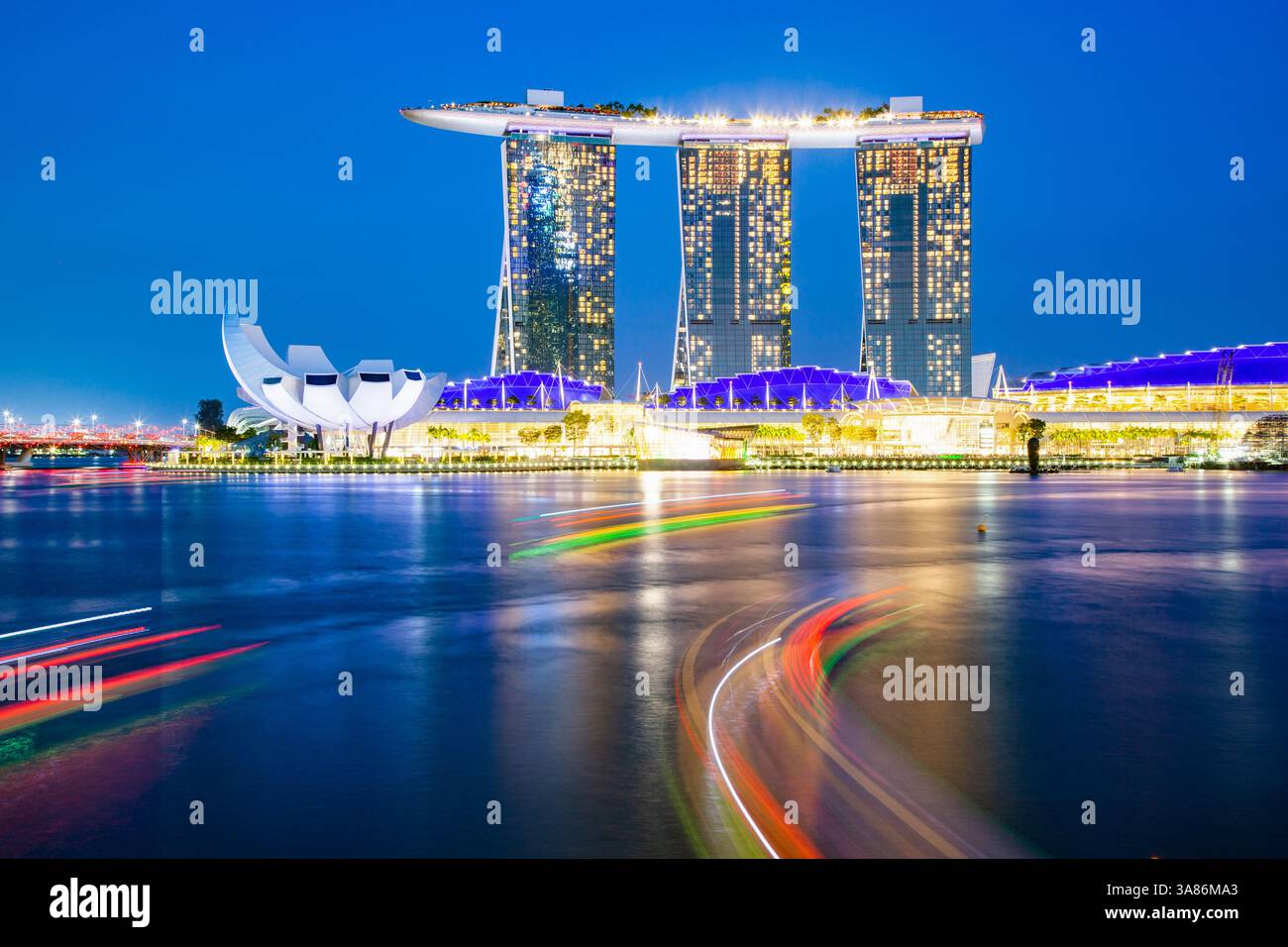 Skyline of Singapore Marina Bay at night with Marina Bay Sands, Art Science museum and tourist ...