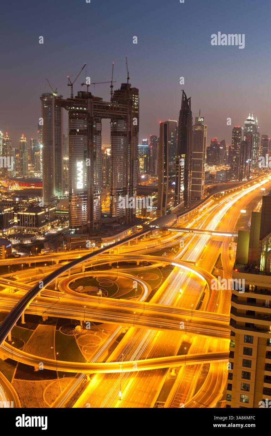 Dubai skyline and night traffic on busy intersection on Sheikh Zayed ...