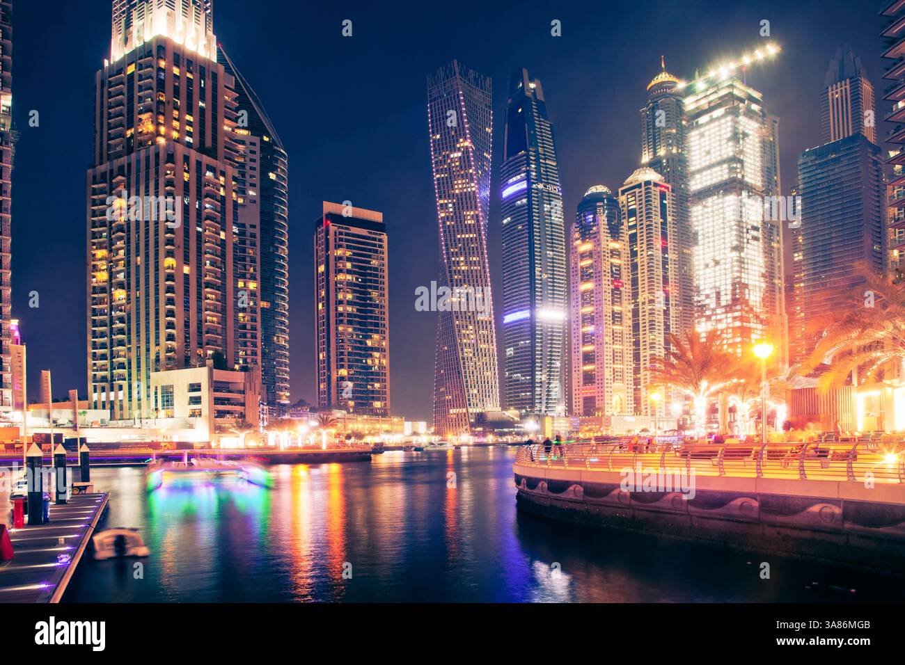 Colorful evening on canal and promenade in Dubai Marina, Dubai, United ...