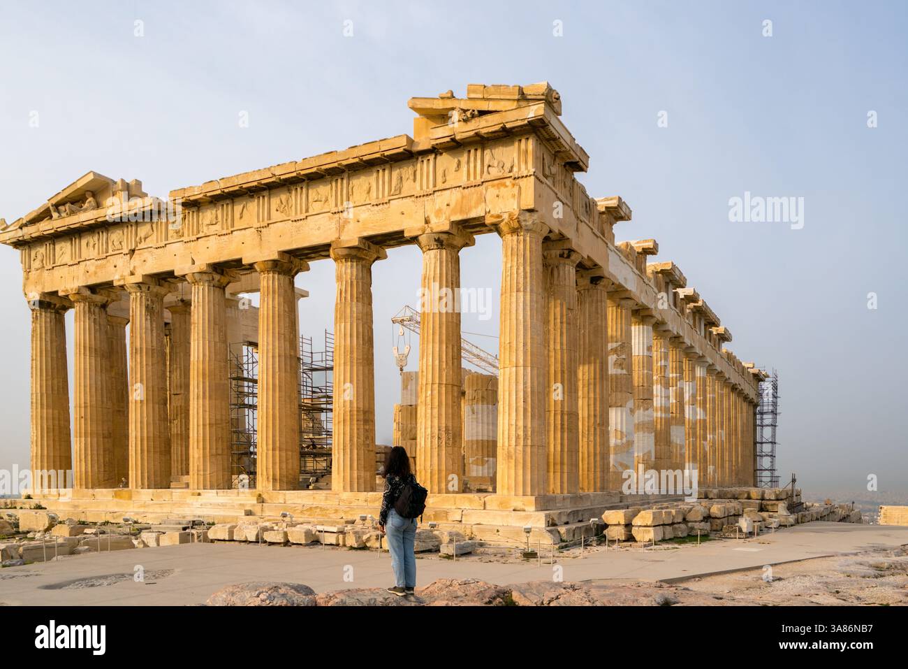 Woman looking at ancient temple dedicated to goddess Athena, Parthenon, UNESCO, Athens, Greece ...