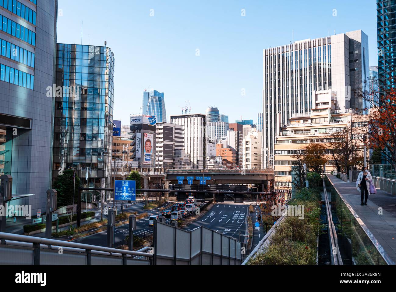 A vibrant view of Tokyo skyline featuring train tracks weaving through ...