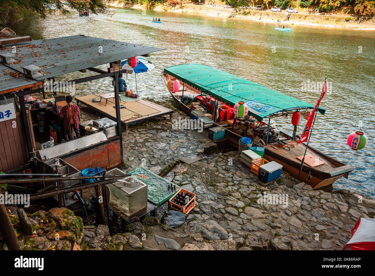 Traditional docked rowboats along Katsura River in Kyoto, Honshu, Japan ...