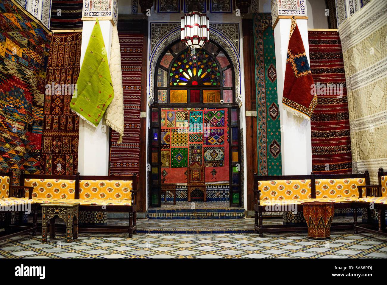 Shop interior with stacks of vibrant handwoven Moroccan rugs and ...