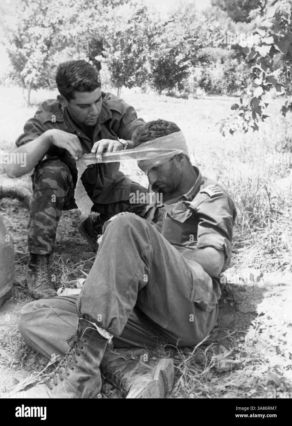 An Israeli soldier bandages a comrade wounded in the fierce fighting ...