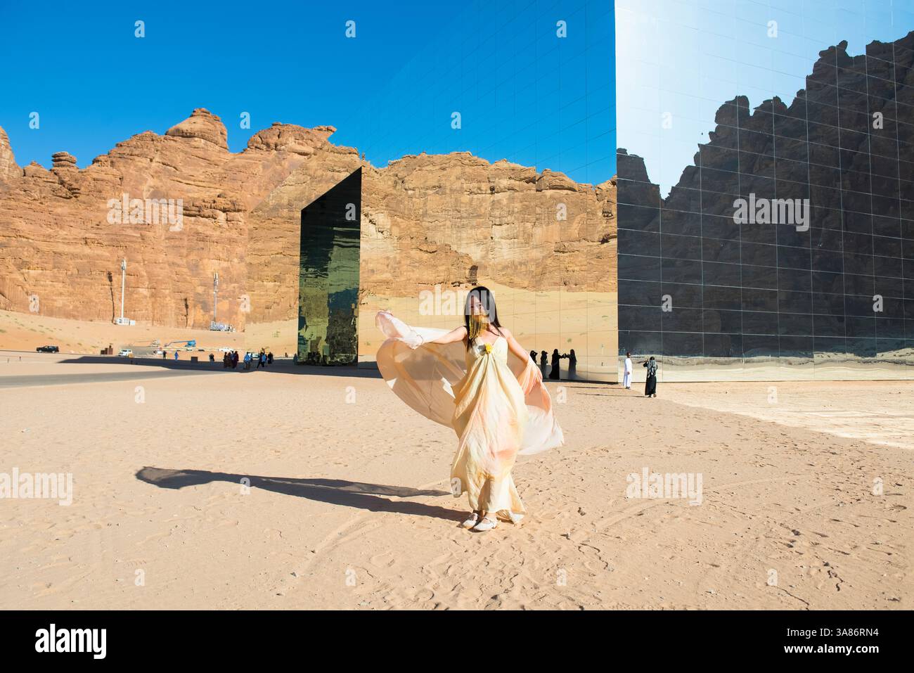 Woman posing in front of the Maraya Theatre, architect Studio Gio Forma ...