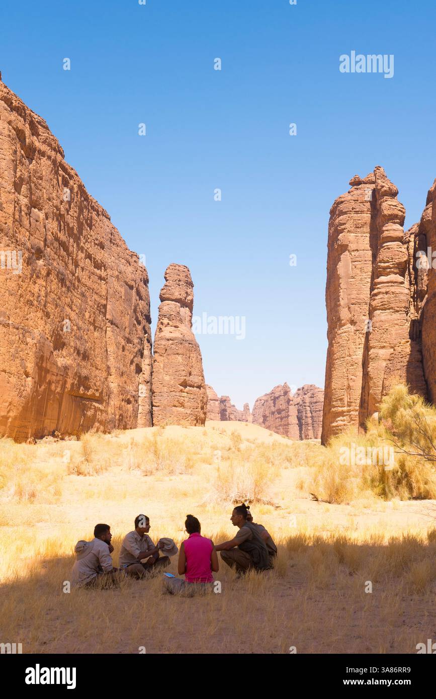 People meeting in front of magnificent sandstone rock structure ...