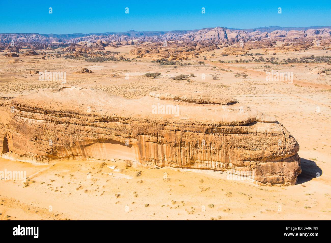Aerial of tombs carved in sandstone rock of Jabal Banat (Qasr al-Bint ...