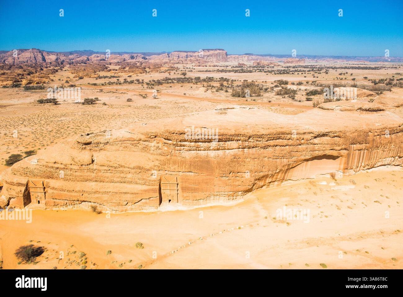 Aerial of tombs carved in sandstone rock of Jabal Banat (Qasr al-Bint ...