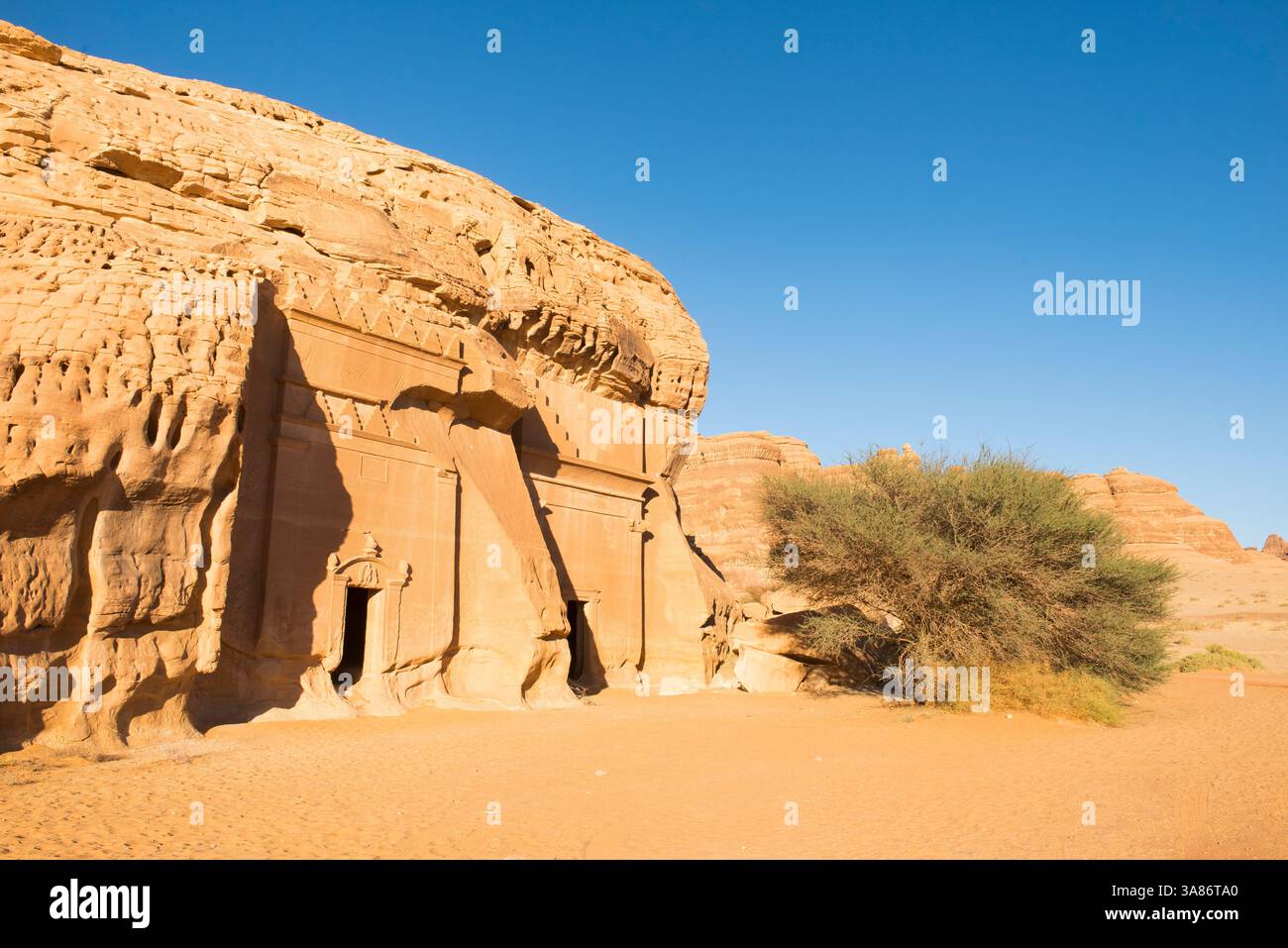 Tombs carved into sandstone rock of Jabal Banat (Qasr Al-Bint) area in ...