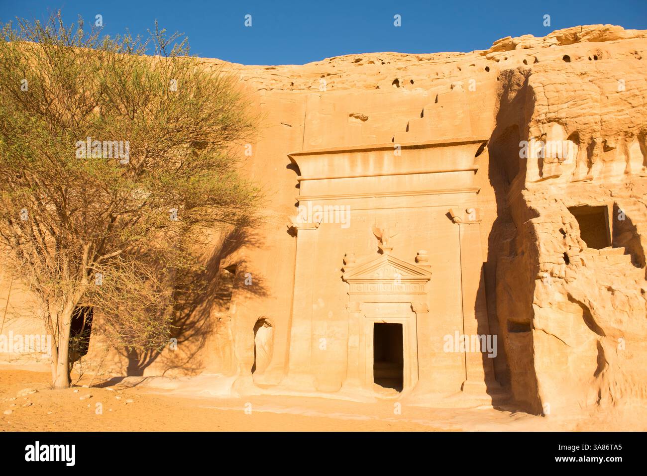 Tombs carved into sandstone rock of Jabal Banat (Qasr Al-Bint) area in ...