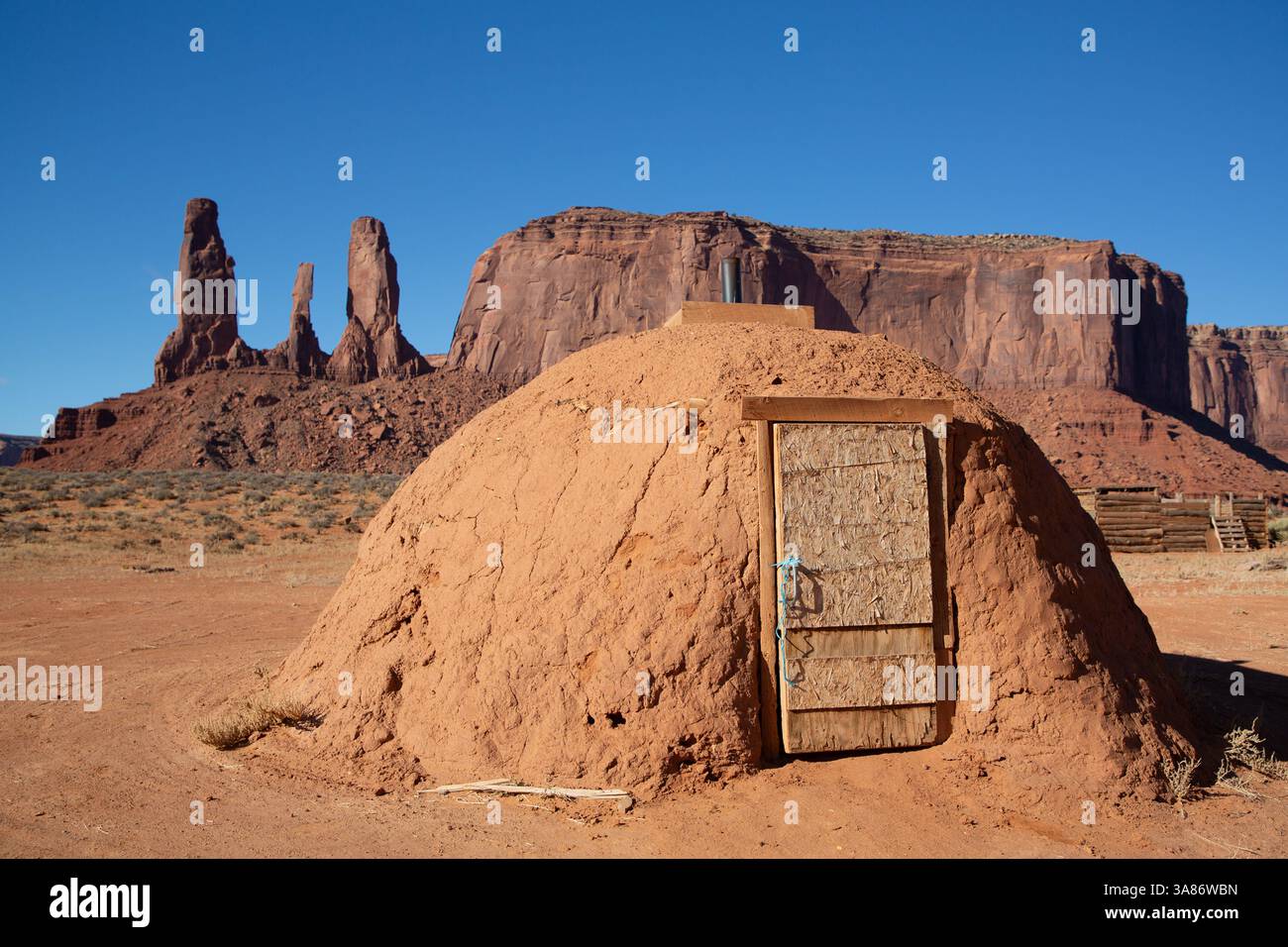Navajo Hogan House, Three Sisters in the background, Monument Valley ...