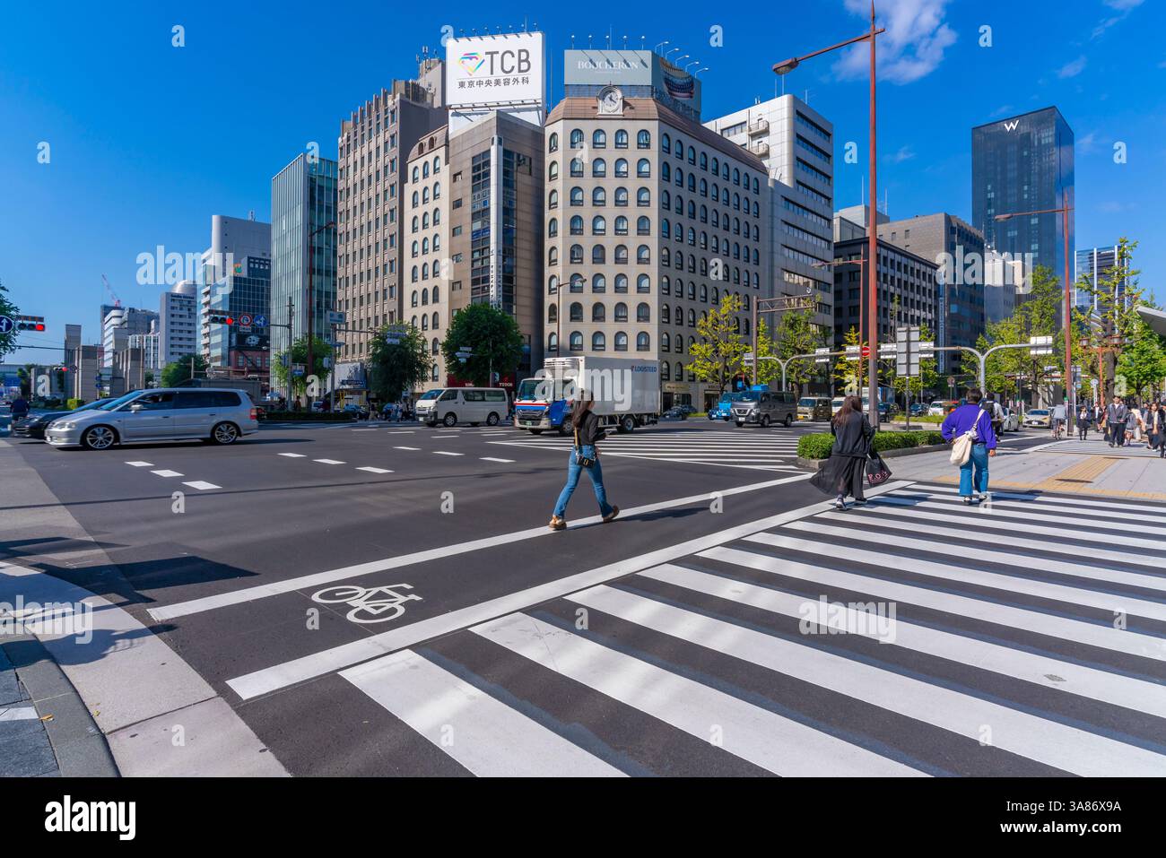View of shops and traffic on busy shopping street, Osaka, Honshu, Japan ...