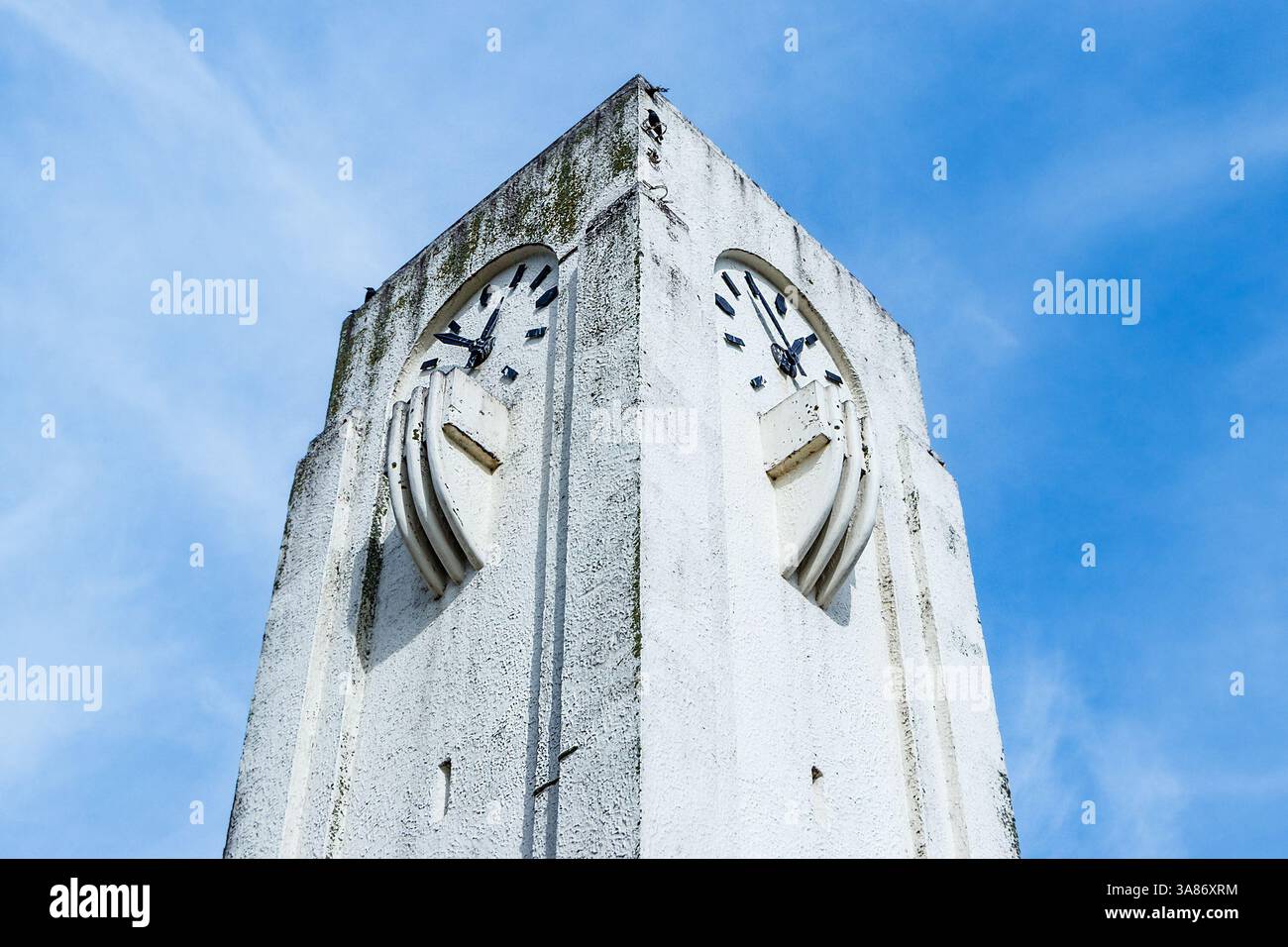 Tall white art deco clock tower with two clock faces part of seaton ...
