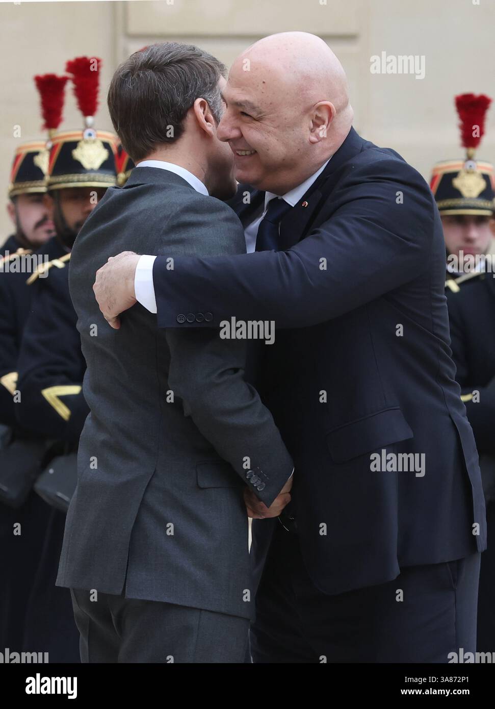 French President Emmanuel Macron (L) greets his Lebanese counterpart ...