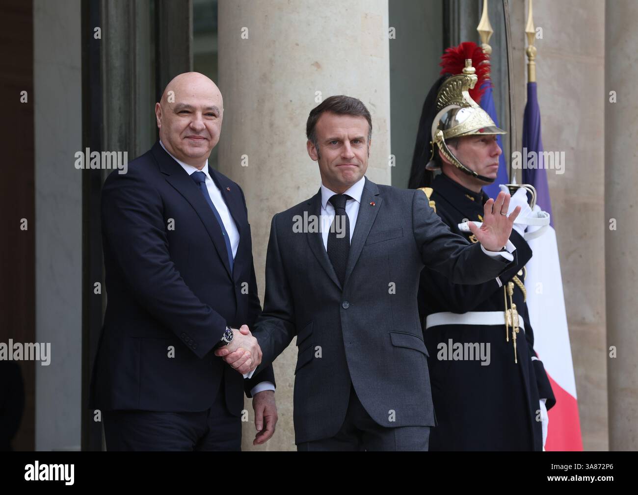 French President Emmanuel Macron (R) greets his Lebanese counterpart ...