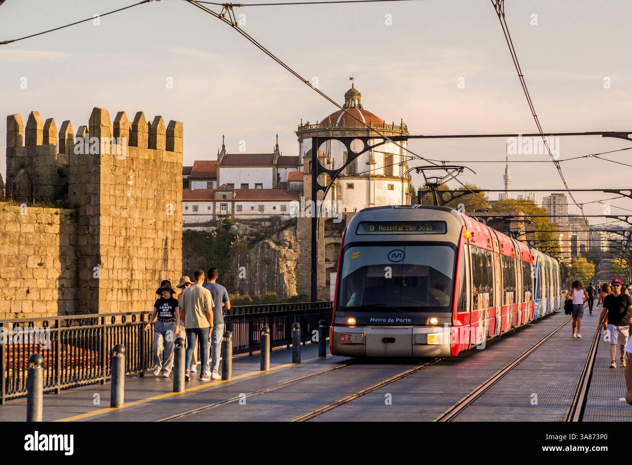 The Metro light rail line on the The Dom Luís I Bridge and the Walls of ...