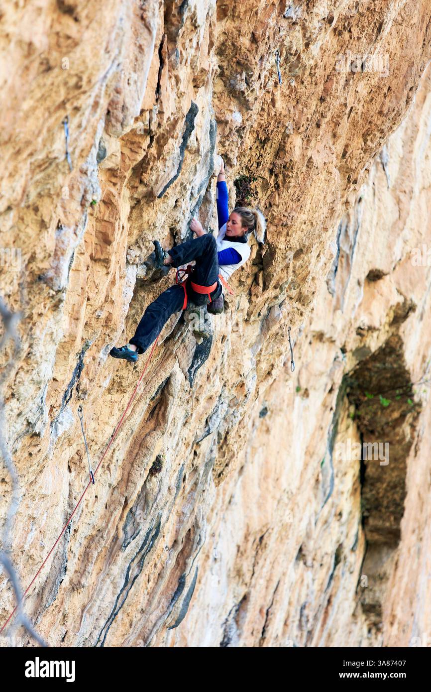 Rock climber in action on the world-famous limestone cliffs of Chulilla ...