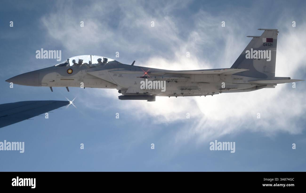 A Qatar Emiri Air Force F-15QA Ababil flies in formation with a U.S ...