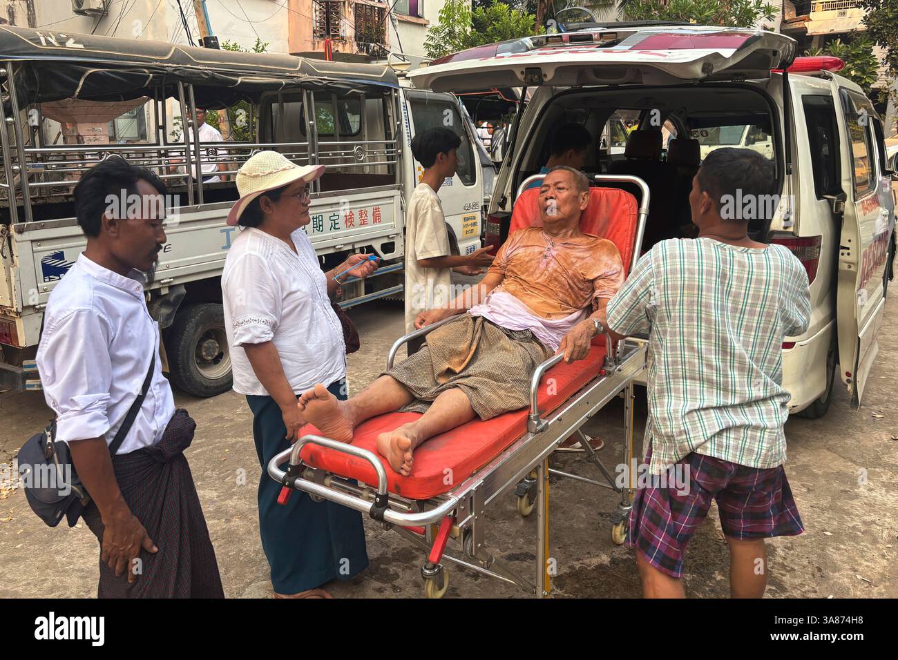 Rescue workers take an injured man who was trapped under a building ...
