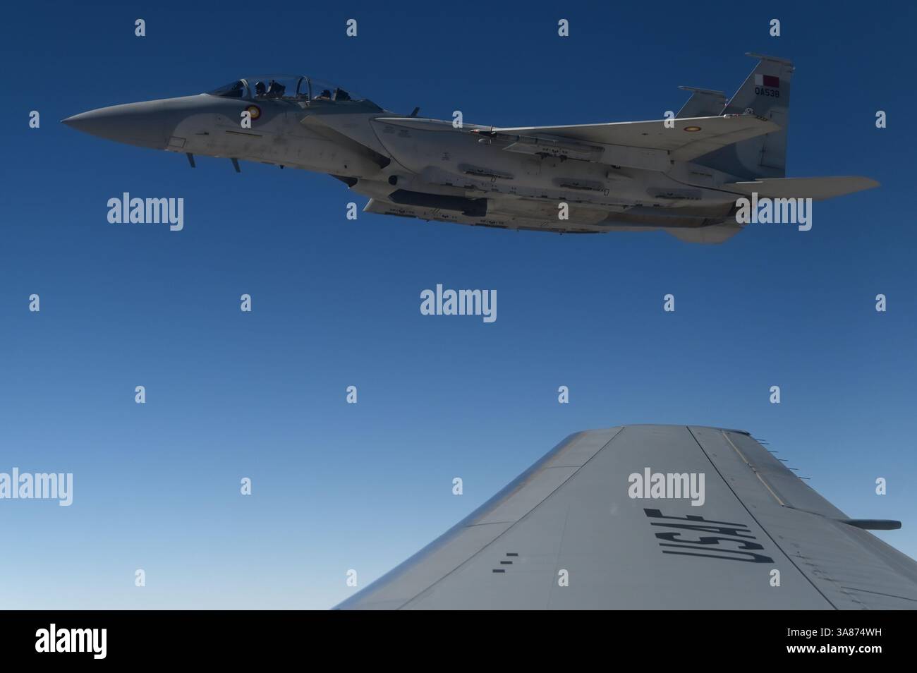 A Qatar Emiri Air Force F-15QA Ababil flies in formation with a U.S ...