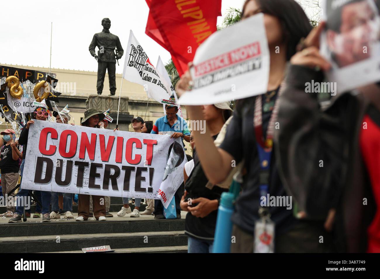 Activists hold signs against former Philippine President Rodrigo ...