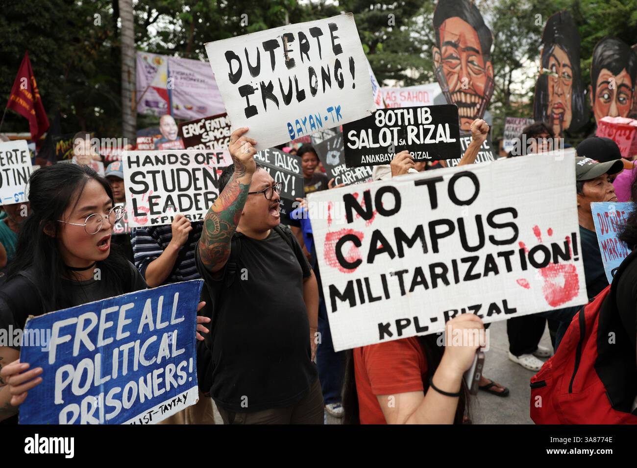 Activists hold signs against former Philippine President Rodrigo ...