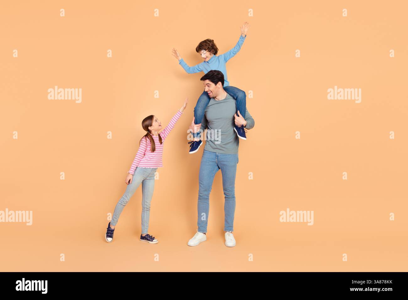 Happy family enjoying quality time together with father carrying son on ...