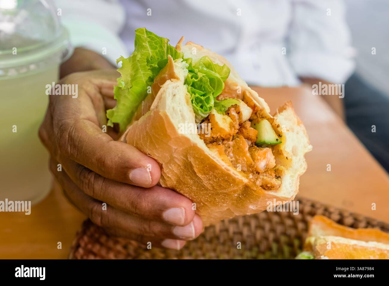 Street food in vietnam hand holding banh mi sandwich close up of ...