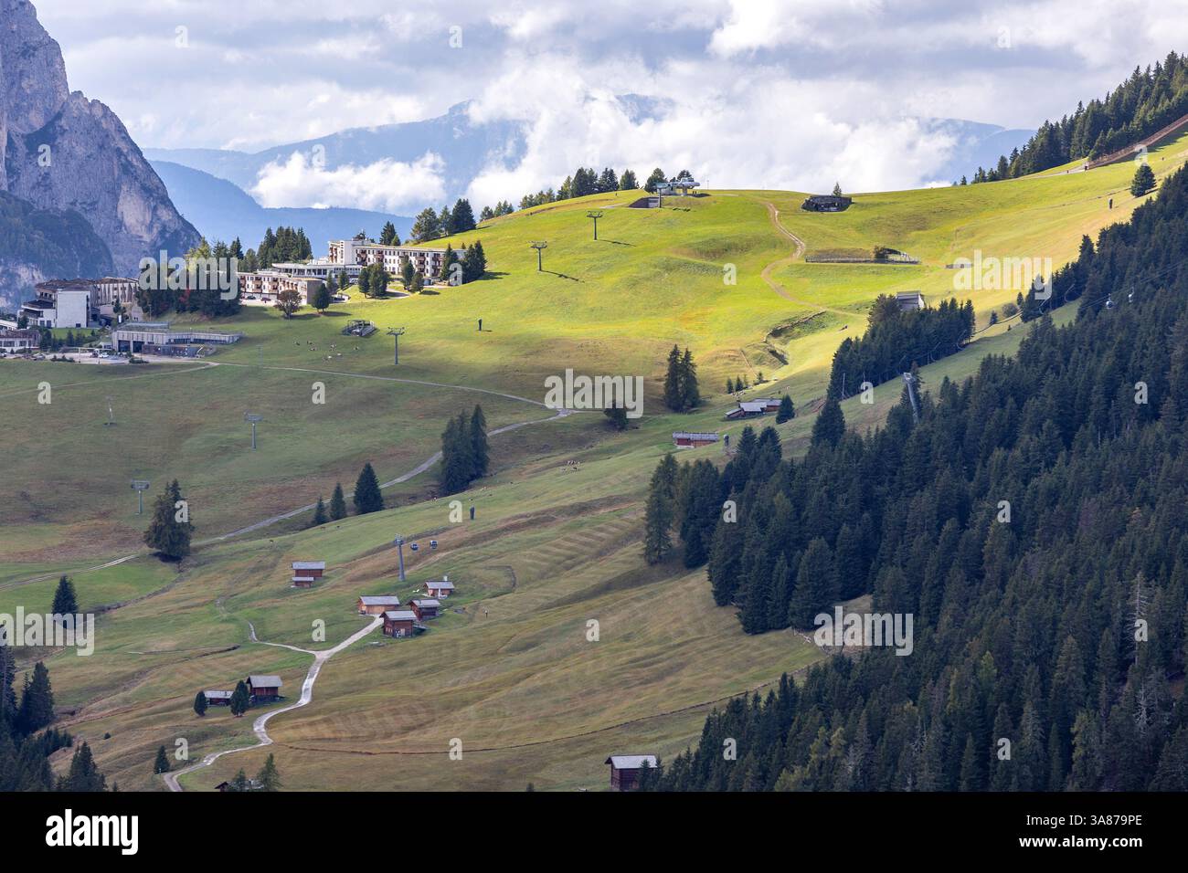 Scenic panorama of Dolomites mountain scenery with traditional wooden ...