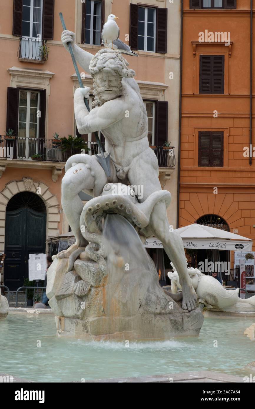 A seagull perches atop the marble statue of Neptune battling an octopus ...
