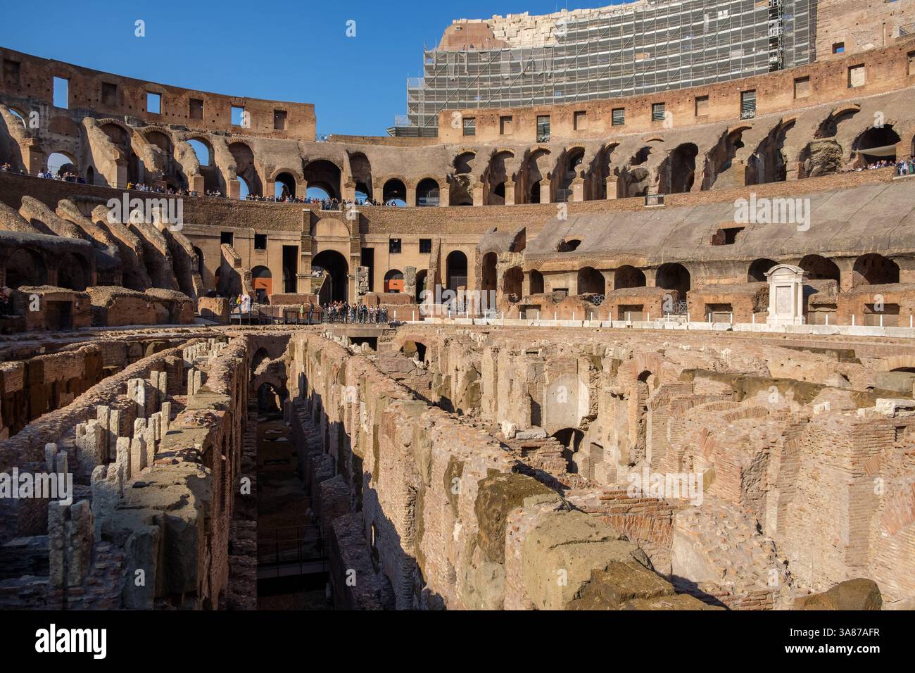 Tourists explore the interior ruins of the ancient Roman Colosseum ...